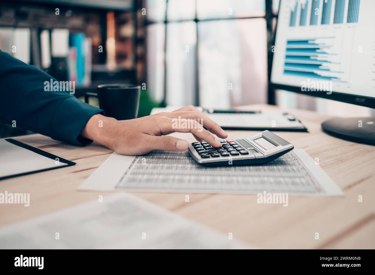 Investors working on desk office and using a calculator to calculate ...