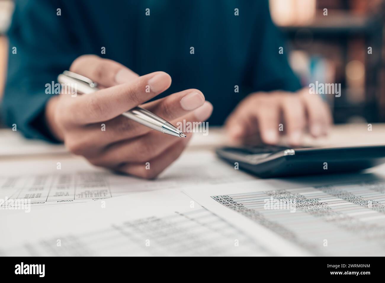 Investors working on desk office and using a calculator to calculate ...