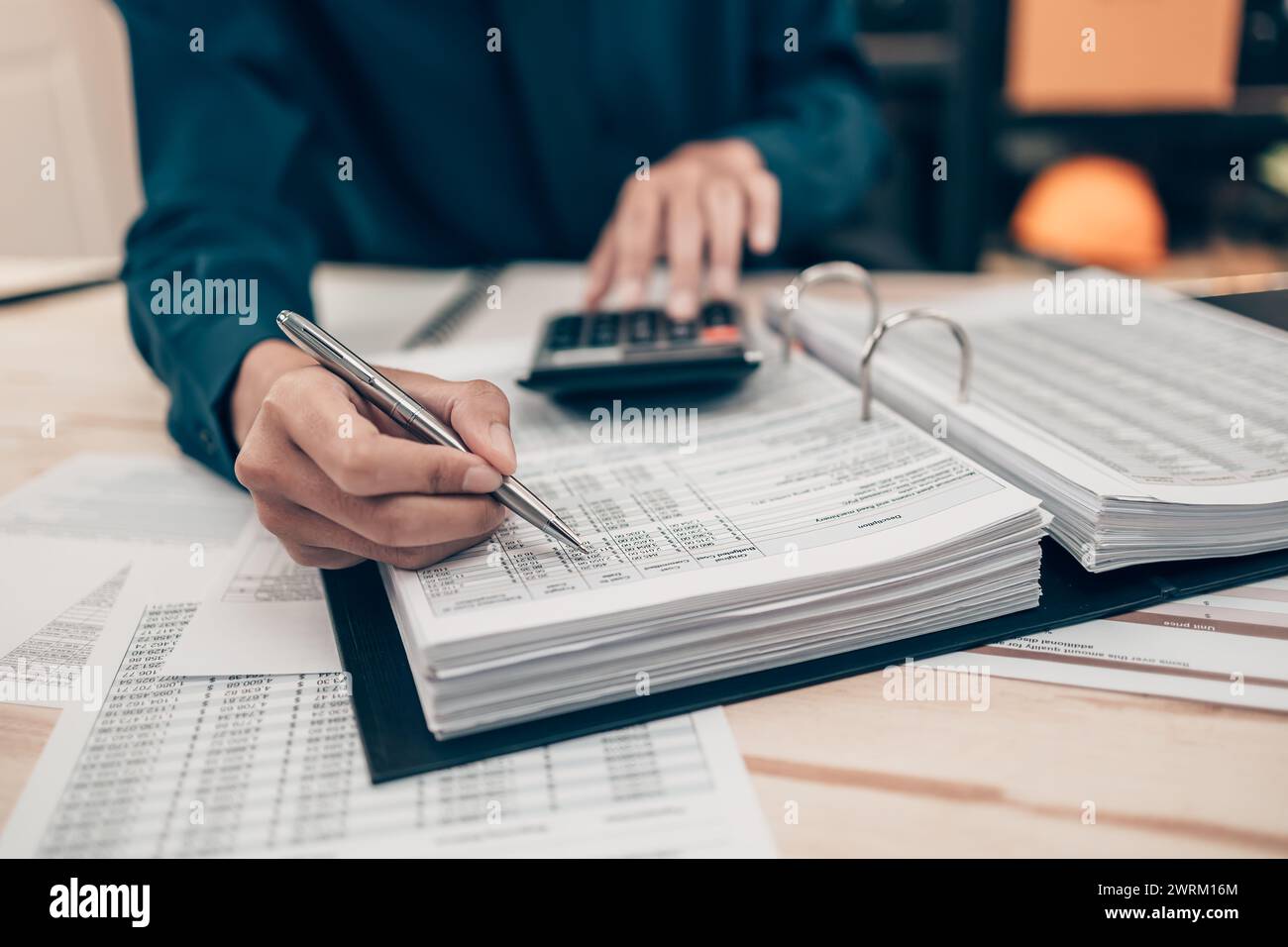 Investors working on desk office and using a calculator to calculate ...