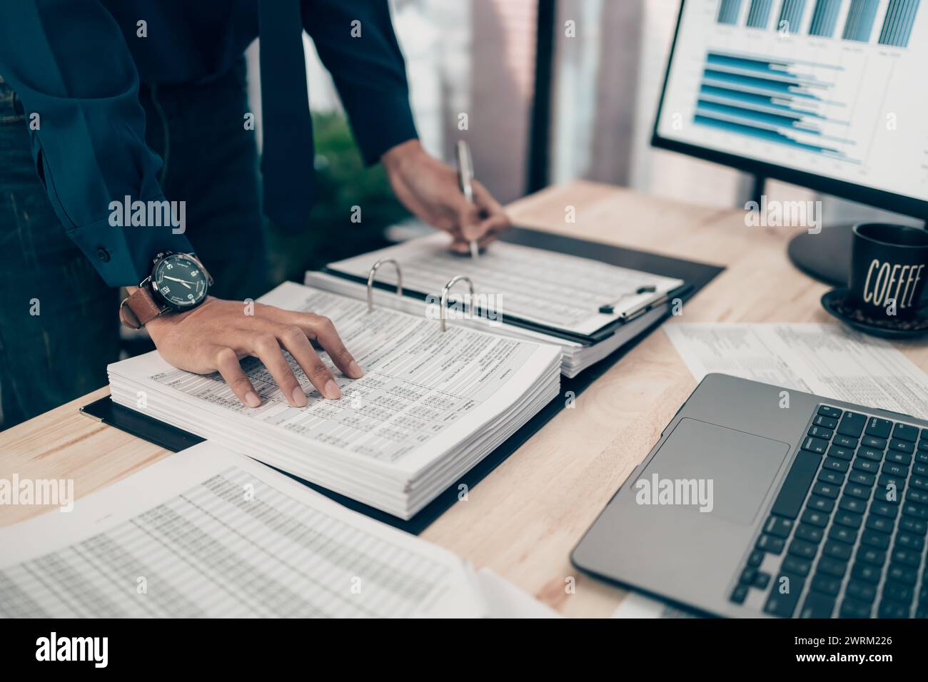 Investors working on desk office and finger pointing to check tracking ...