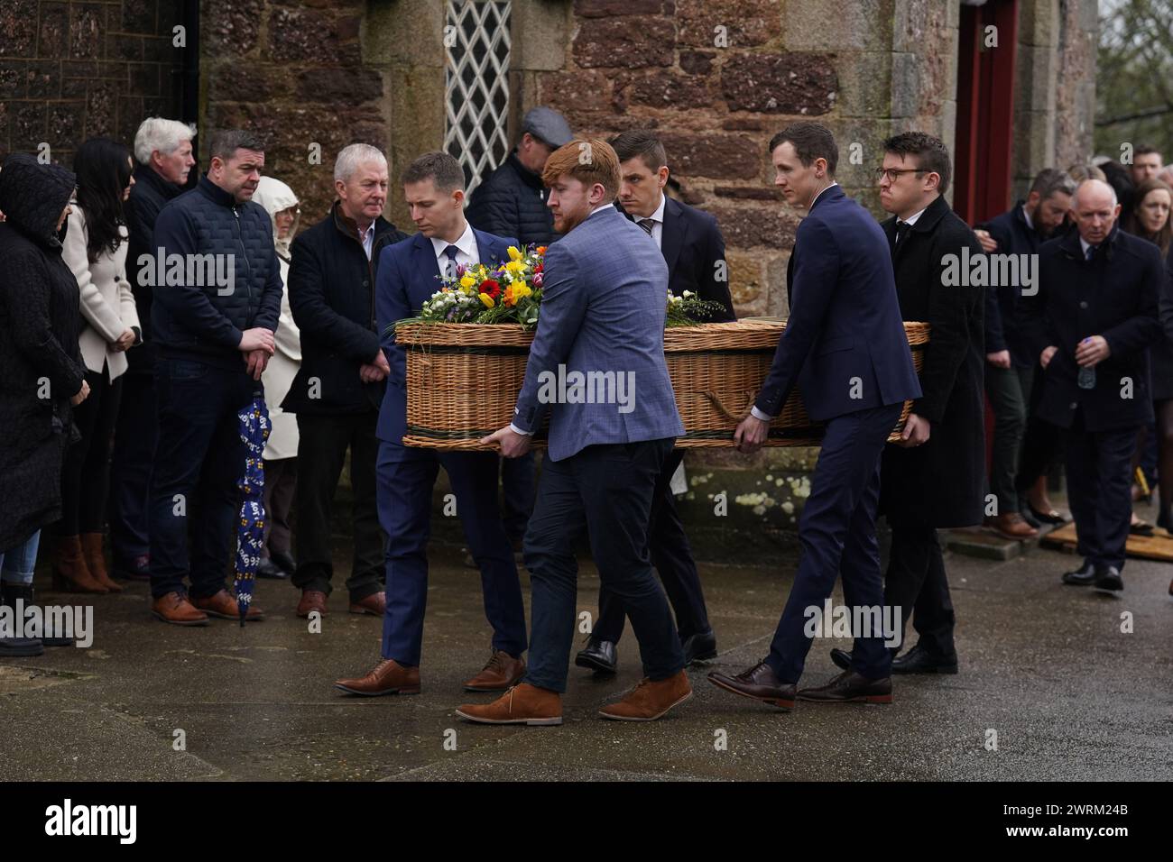 Nick Sheridan's brother Brian (front left) helps carry the casket from ...