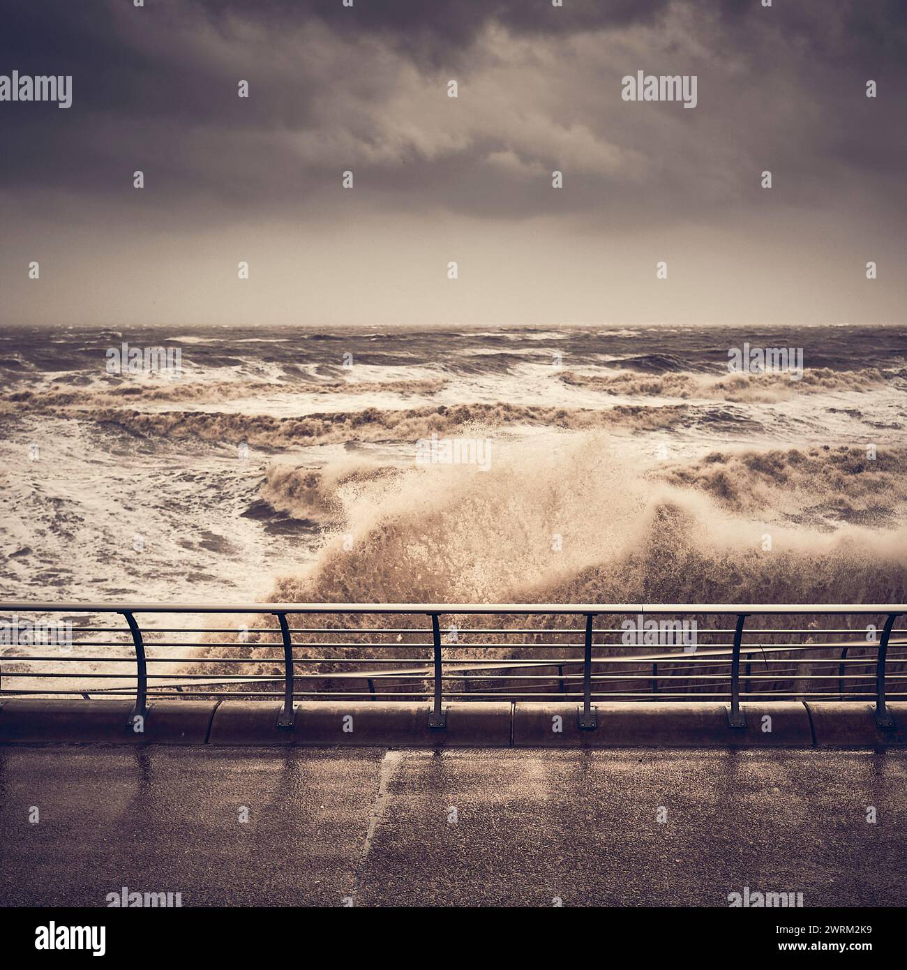 Waves crash over the seawall during a winter storm Stock Photo - Alamy
