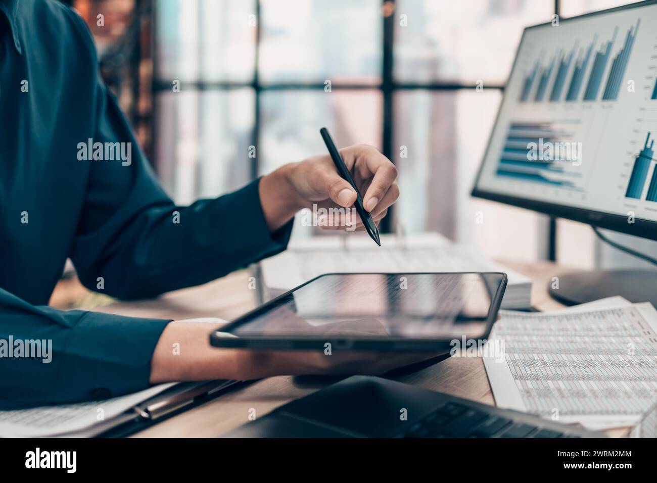 Investors working on desk office and use tablet to check tracking cost ...