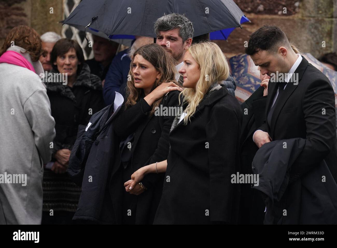 Family members and mourners leave the funeral of TV presenter and ...