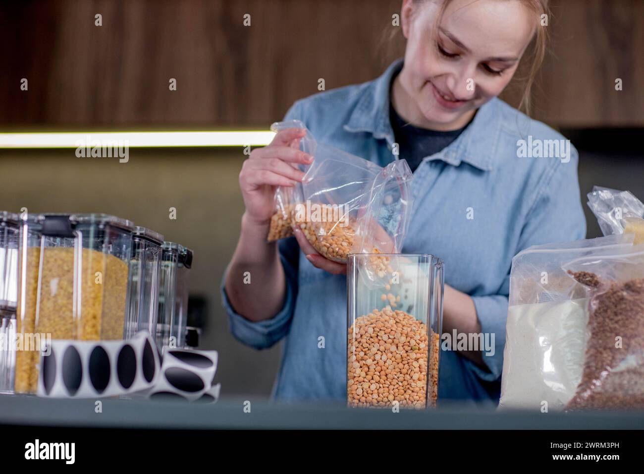 Woman organizing food in the kitchen with containers Stock Photo - Alamy