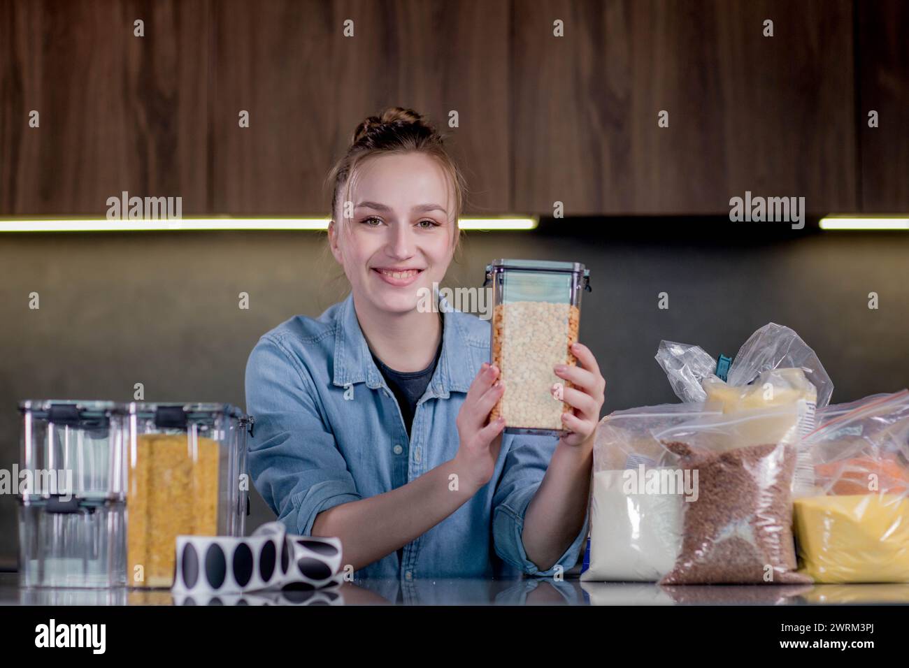 Woman organizing food in the kitchen with containers Stock Photo - Alamy