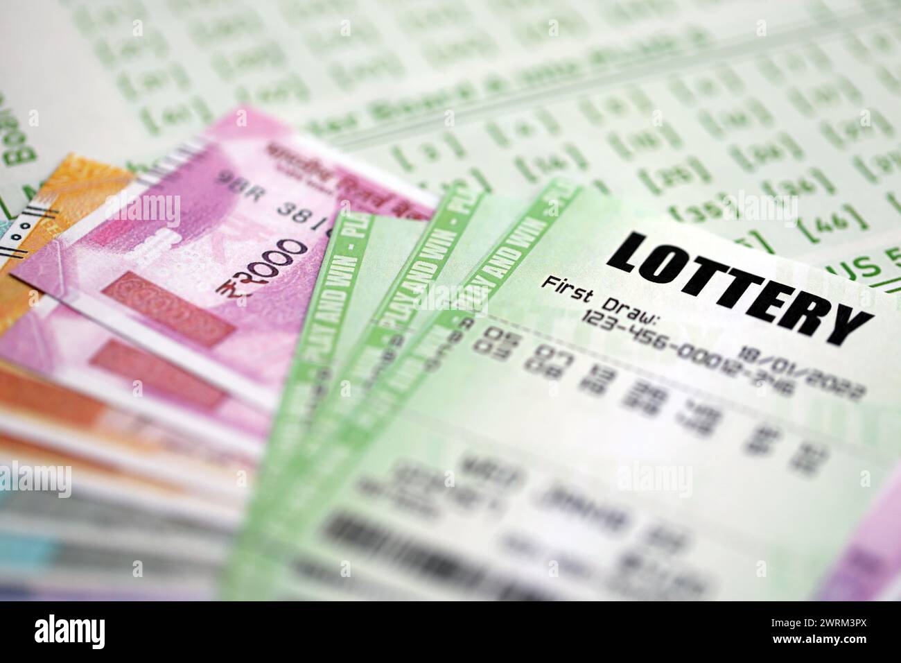 Green lottery tickets and indian rupees money bills on blank with ...