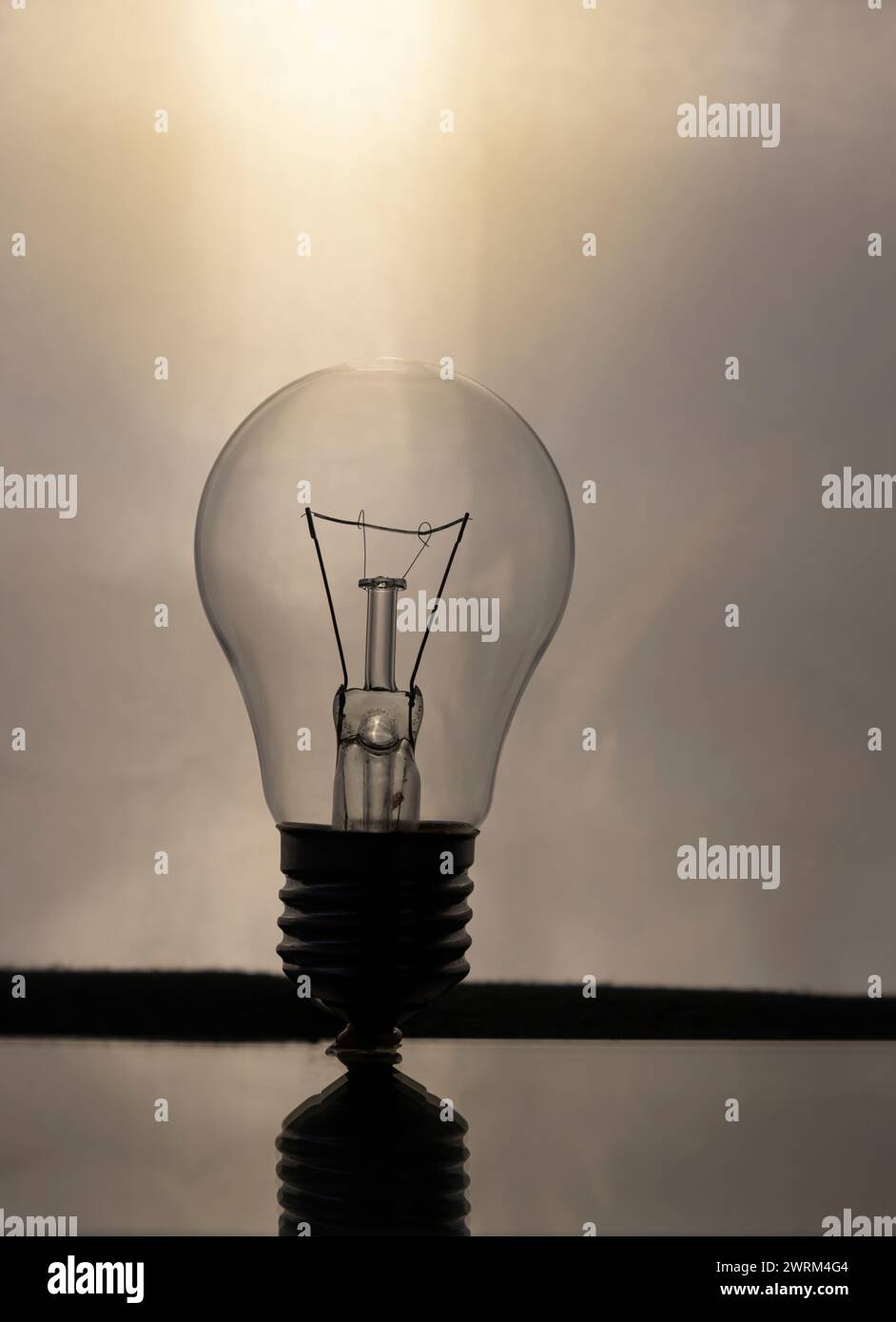 A tungsten light bulb on a smoky background. power outage concept Stock ...
