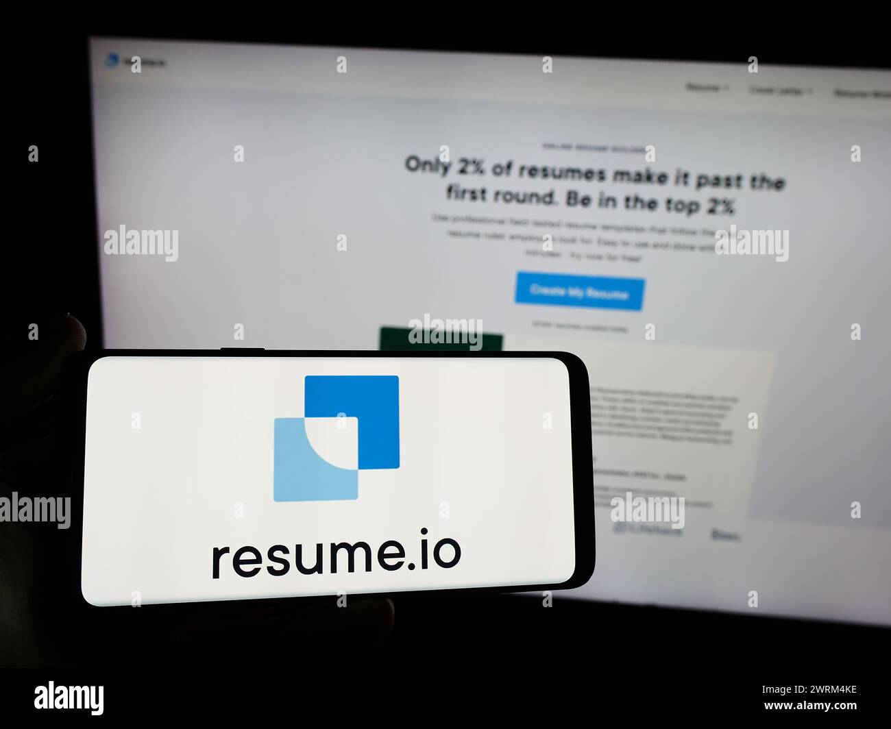 Person holding mobile phone with logo of Dutch resume creator company ...