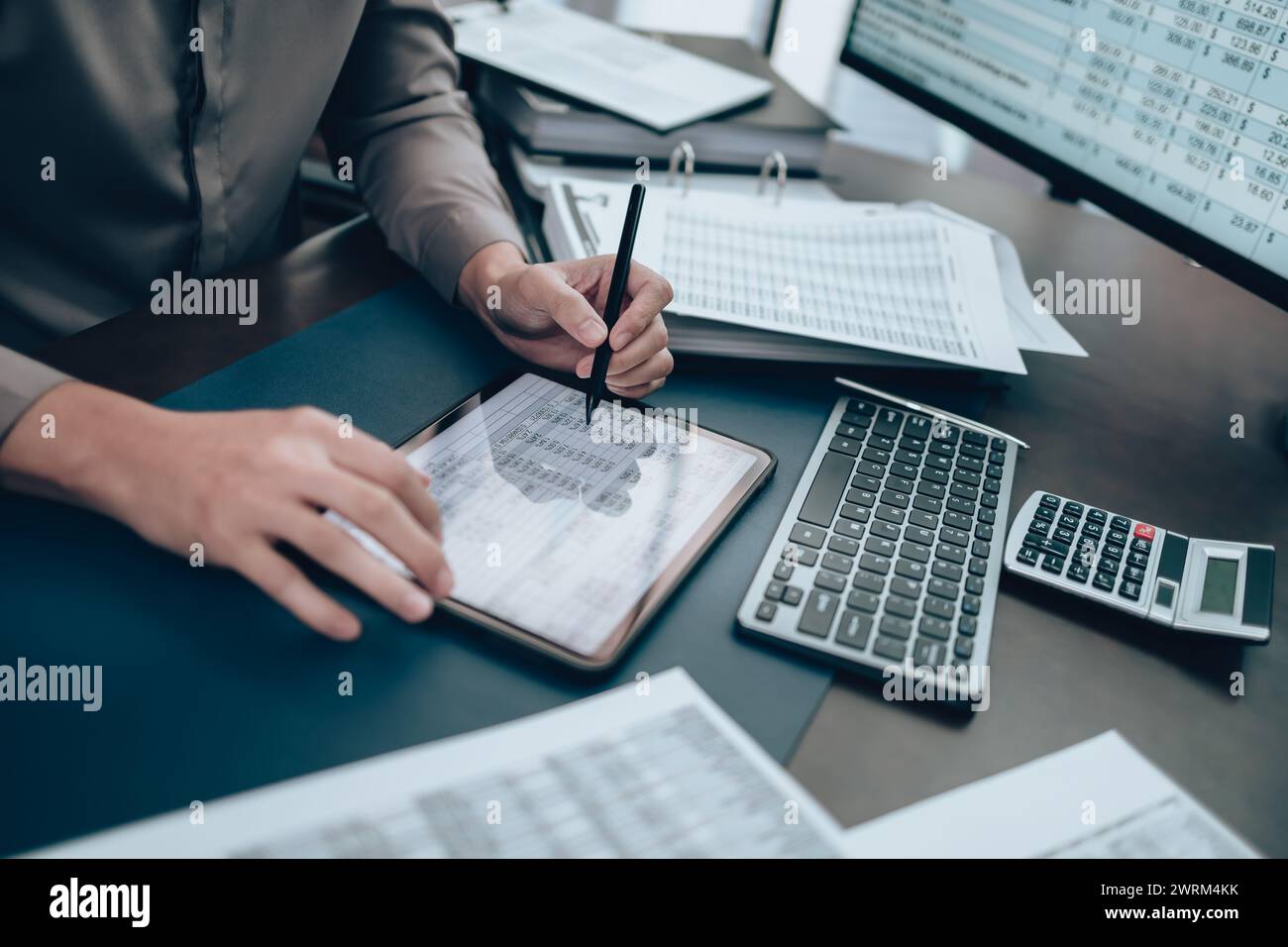 Investors working on desk office and use tablet to check tracking cost ...