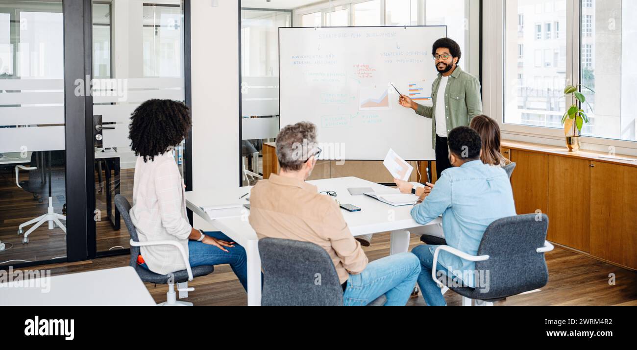 A diverse and dynamic team gathers in a modern office space, where a ...