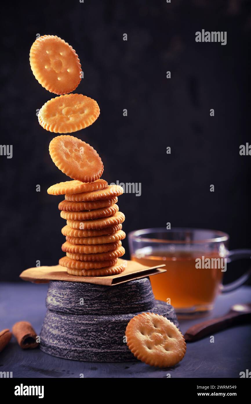 Salted biscuits dance through the air, gracefully landing atop a stack ...
