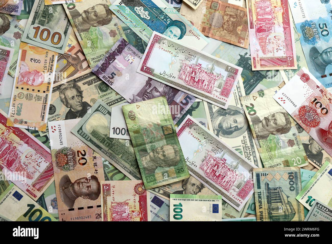 Many banknotes of different currency. Background of big amount of ...