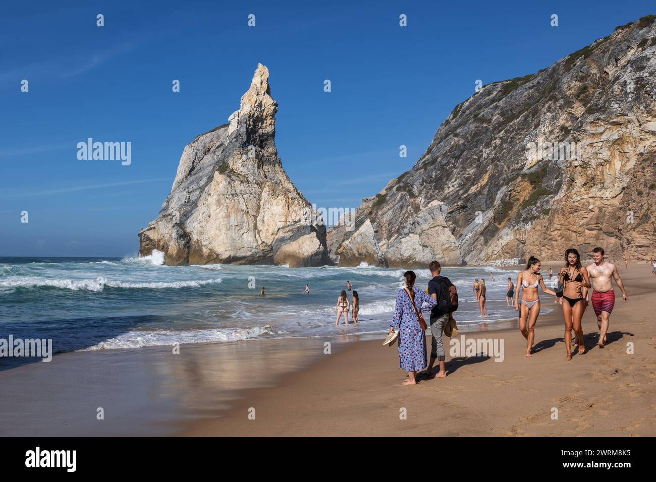 People at the Praia da Ursa beach in Portugal, secluded sandy shore by ...
