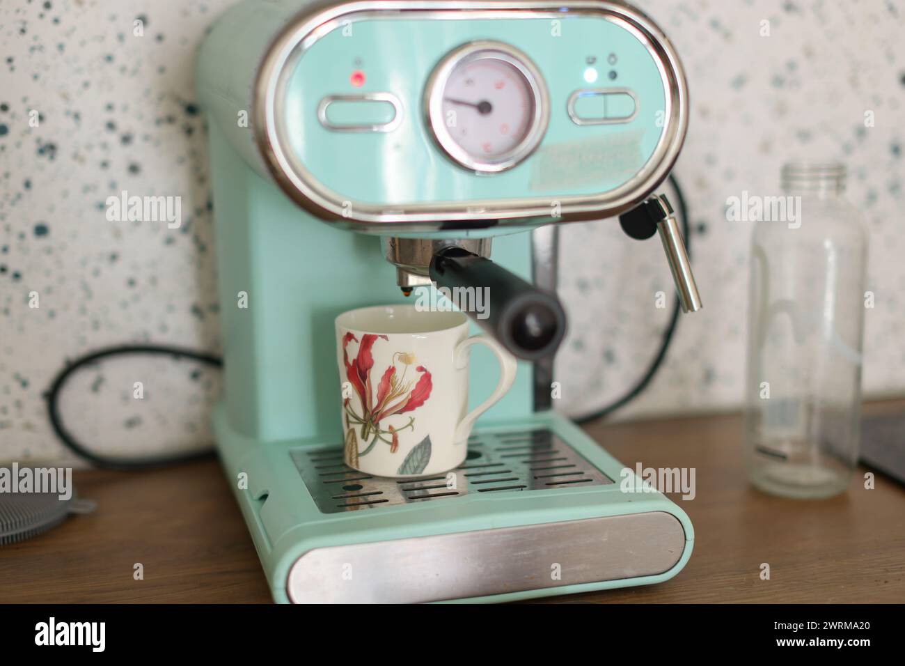 blue coffee machine pours a mug of coffee Stock Photo - Alamy
