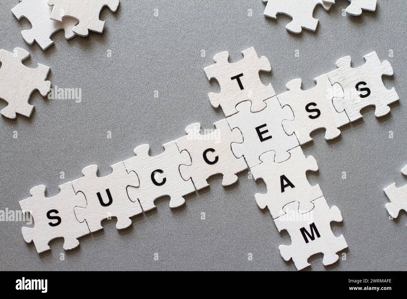 Puzzle pieces with letters forming words team and success, teamwork ...