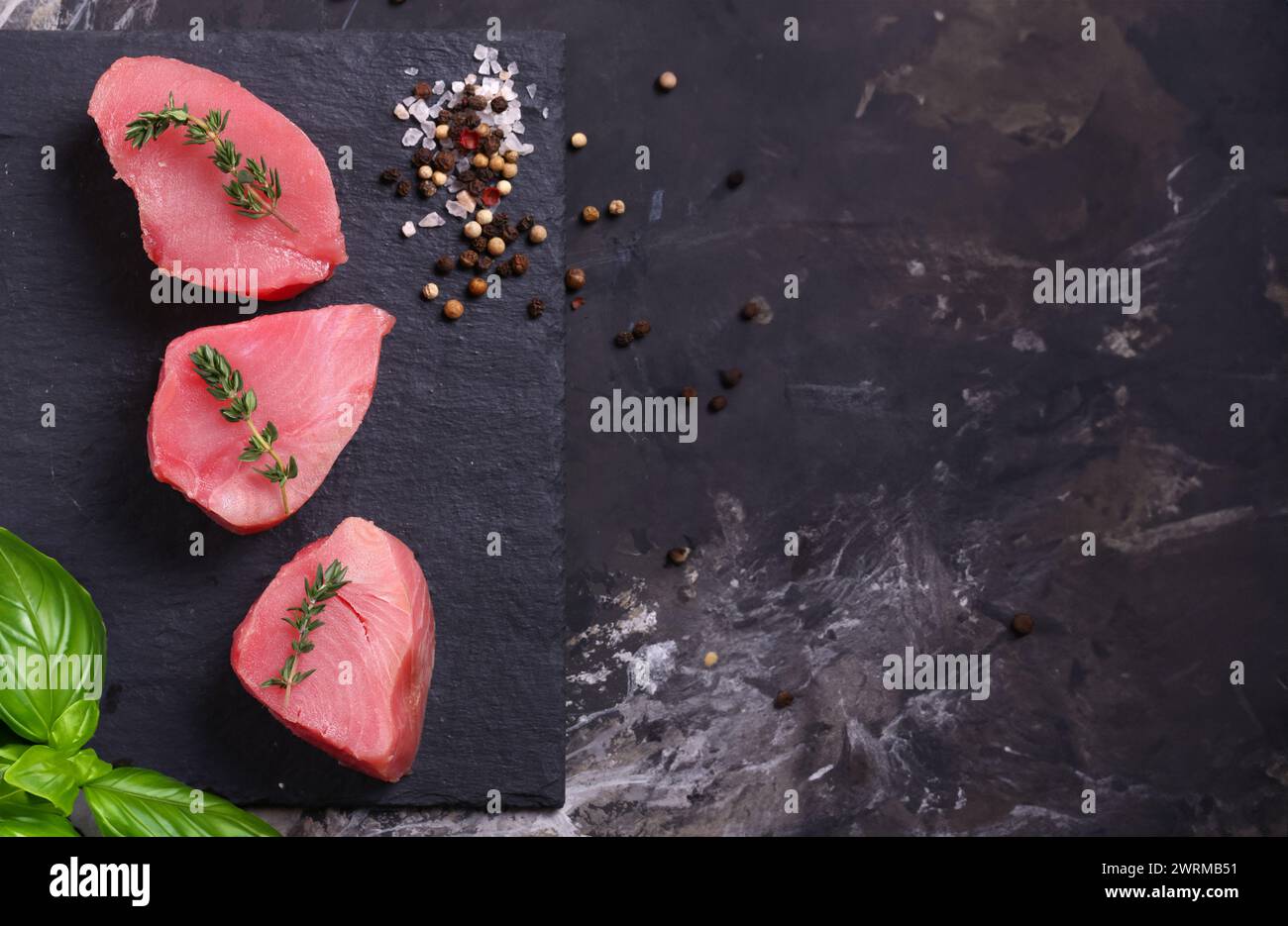 fresh raw tuna fillets on black background Stock Photo - Alamy