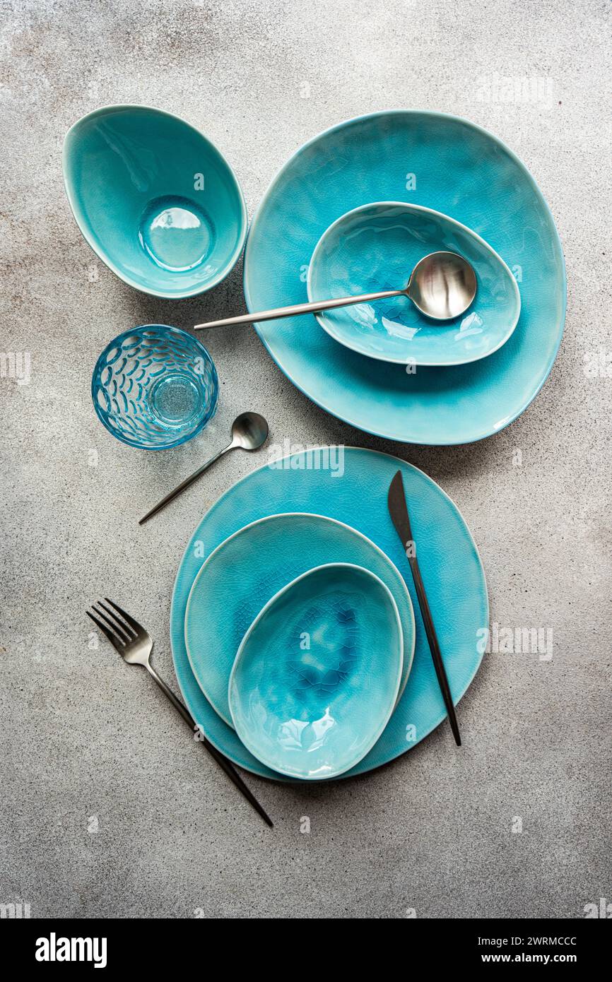 Top view of a stylish turquoise ceramic table setting with matching ...