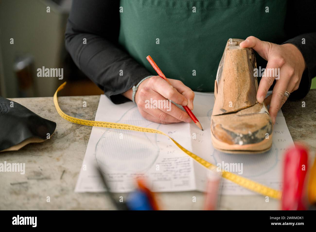 A meticulous cropped unrecognizable shoemaker in Austria works on a ...