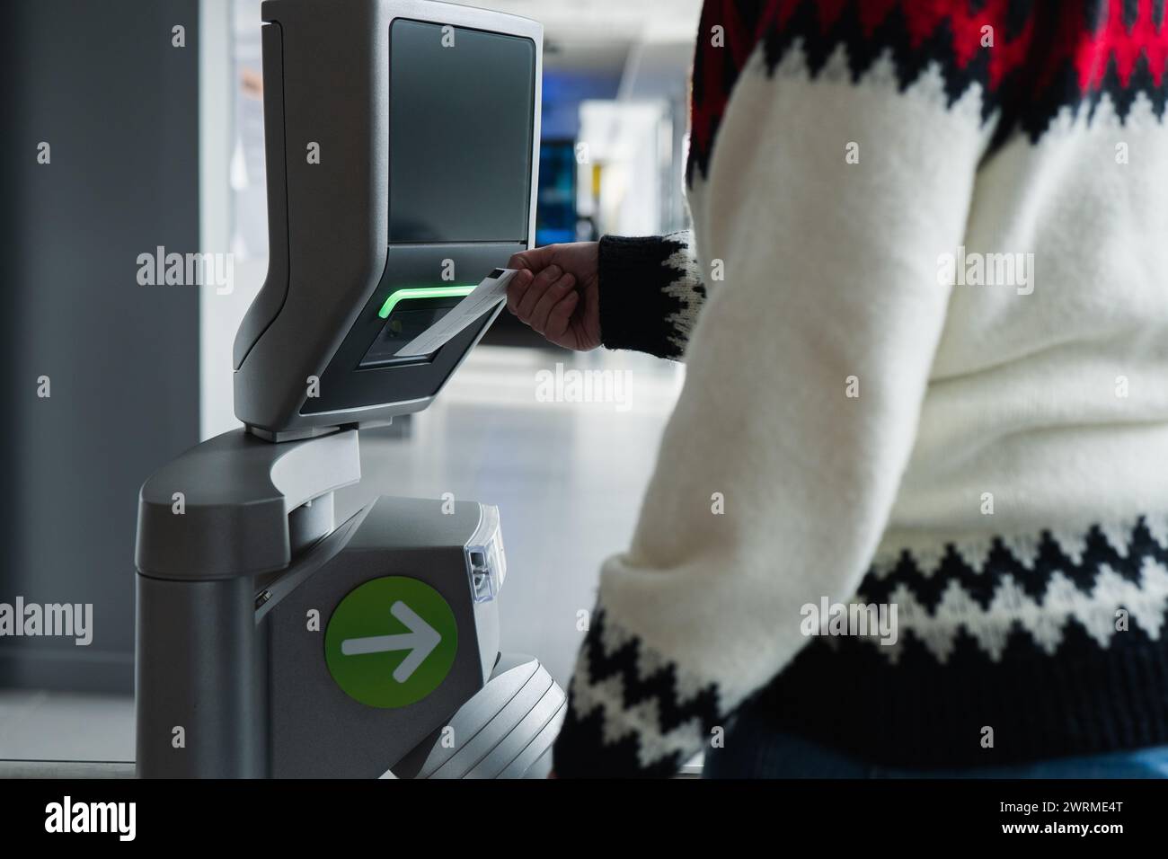 Cropped unrecognizable person is using a modern ticket reading machine ...