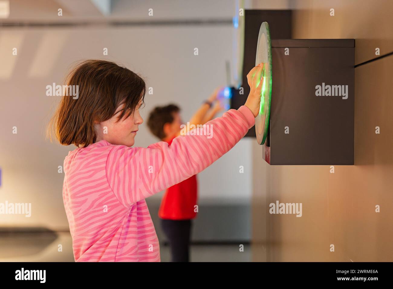 A boy and girl explore and learn with hands-on exhibits at a science ...
