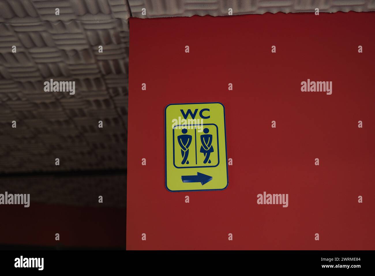 Unisex restroom sign with male and female symbols on a red wall Stock ...