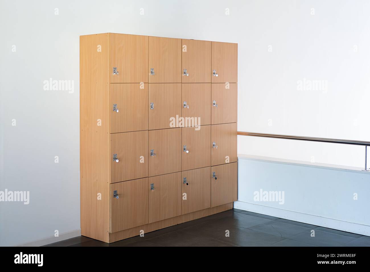 Modern wooden lockers in a bright interior with chrome handles and a ...