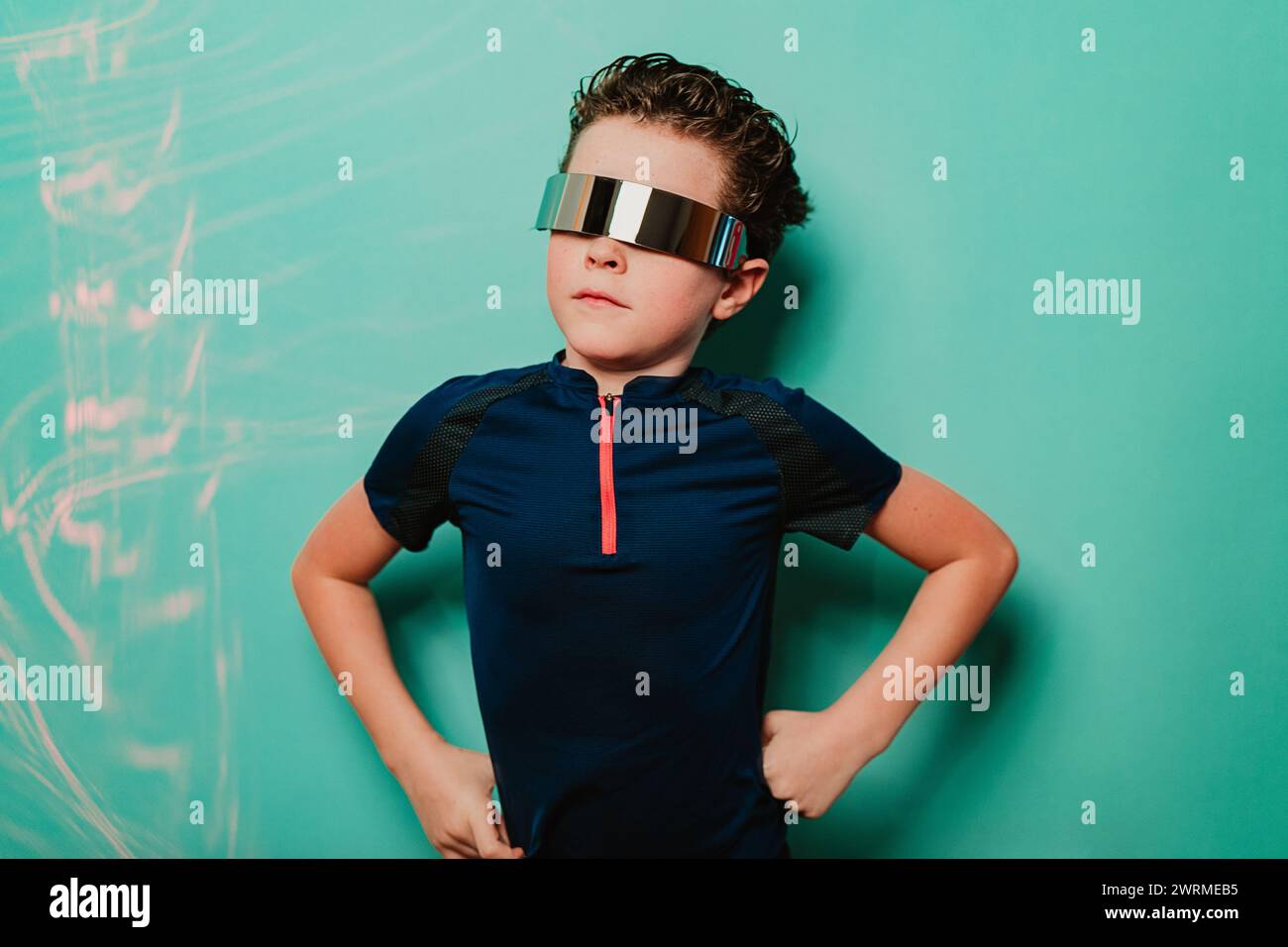 A young boy exudes confidence with his hands on his hips, wearing a ...