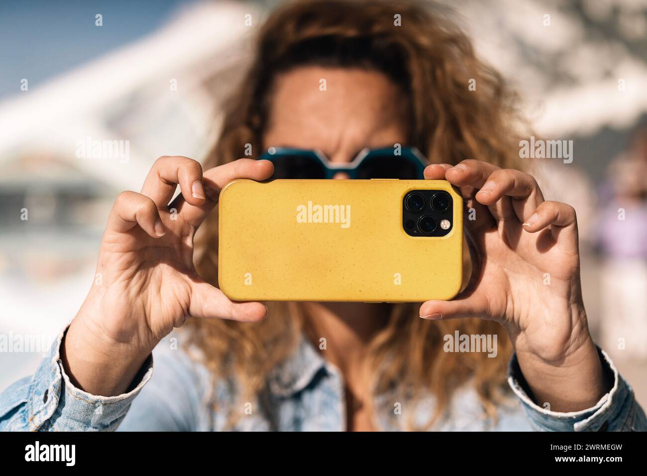 A person with distinctive hands, missing thumbs, captures a moment ...