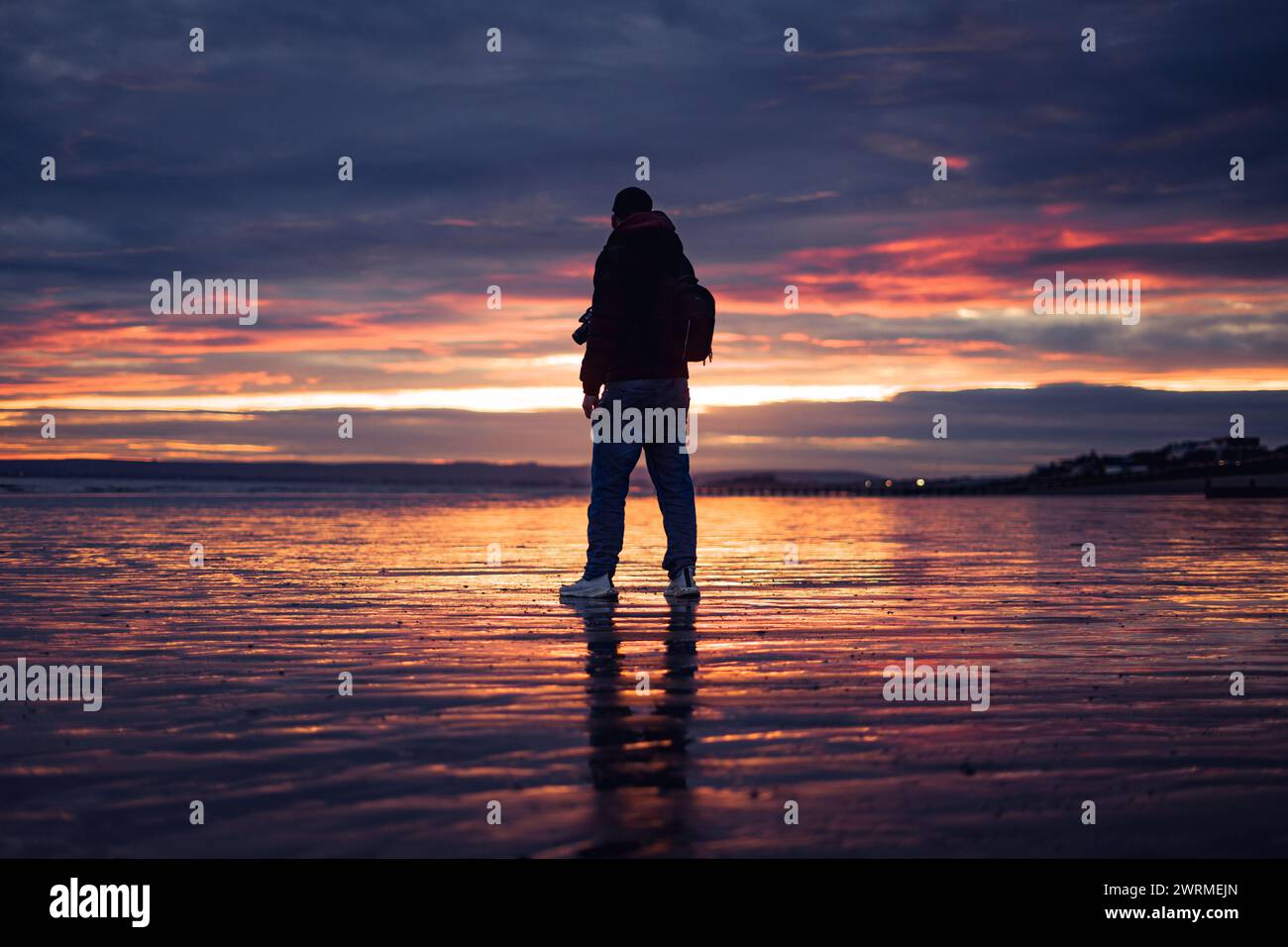 Exploring man on a beach in the UK on a beautiful spring sunset Stock ...