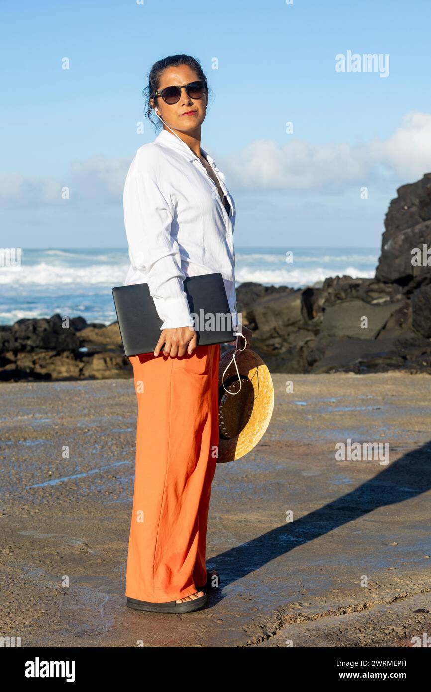 A digital female nomad stands confidently in a quaint fishing village ...