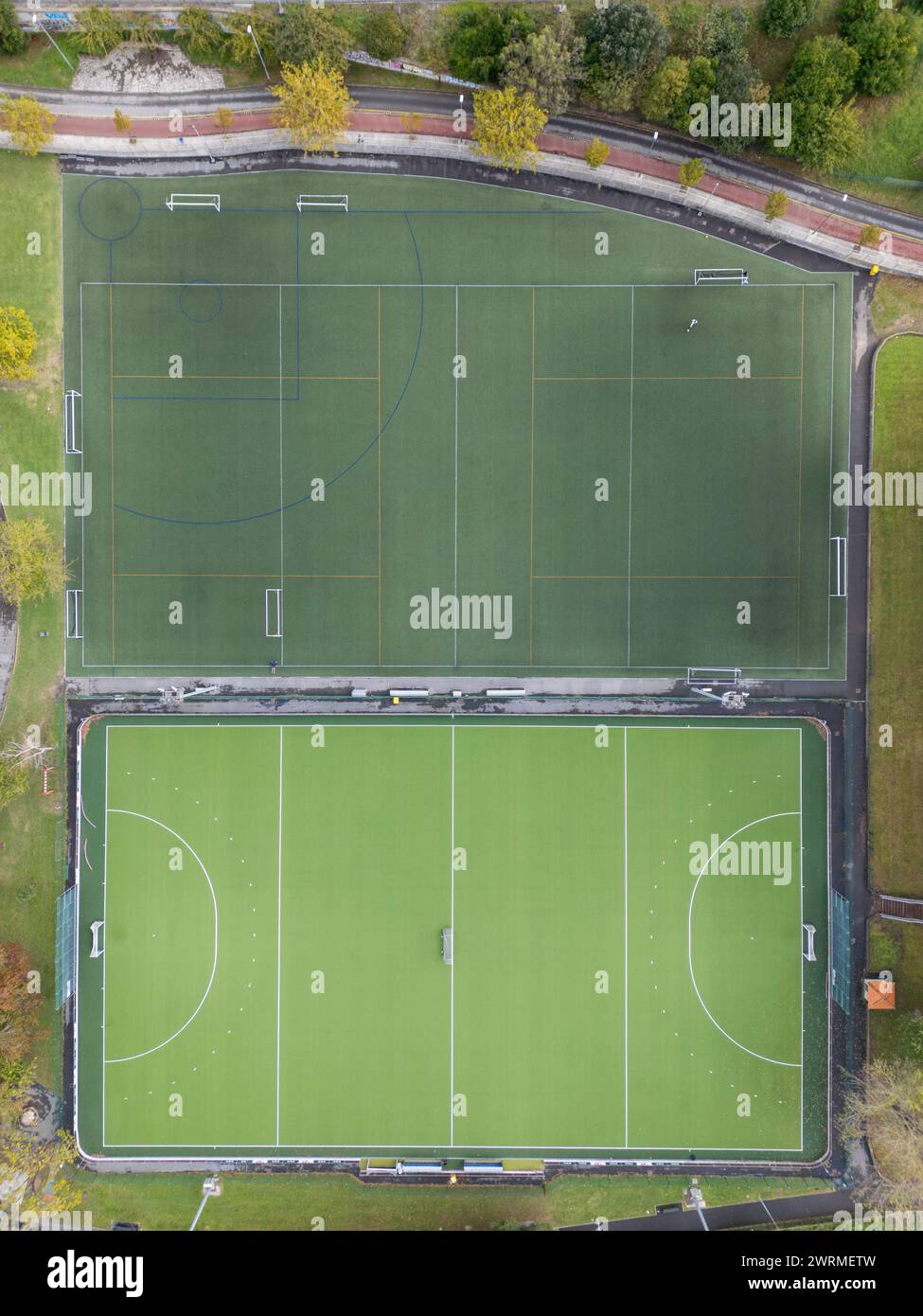 An aerial shot captures two adjacent, empty sports fields with clear ...