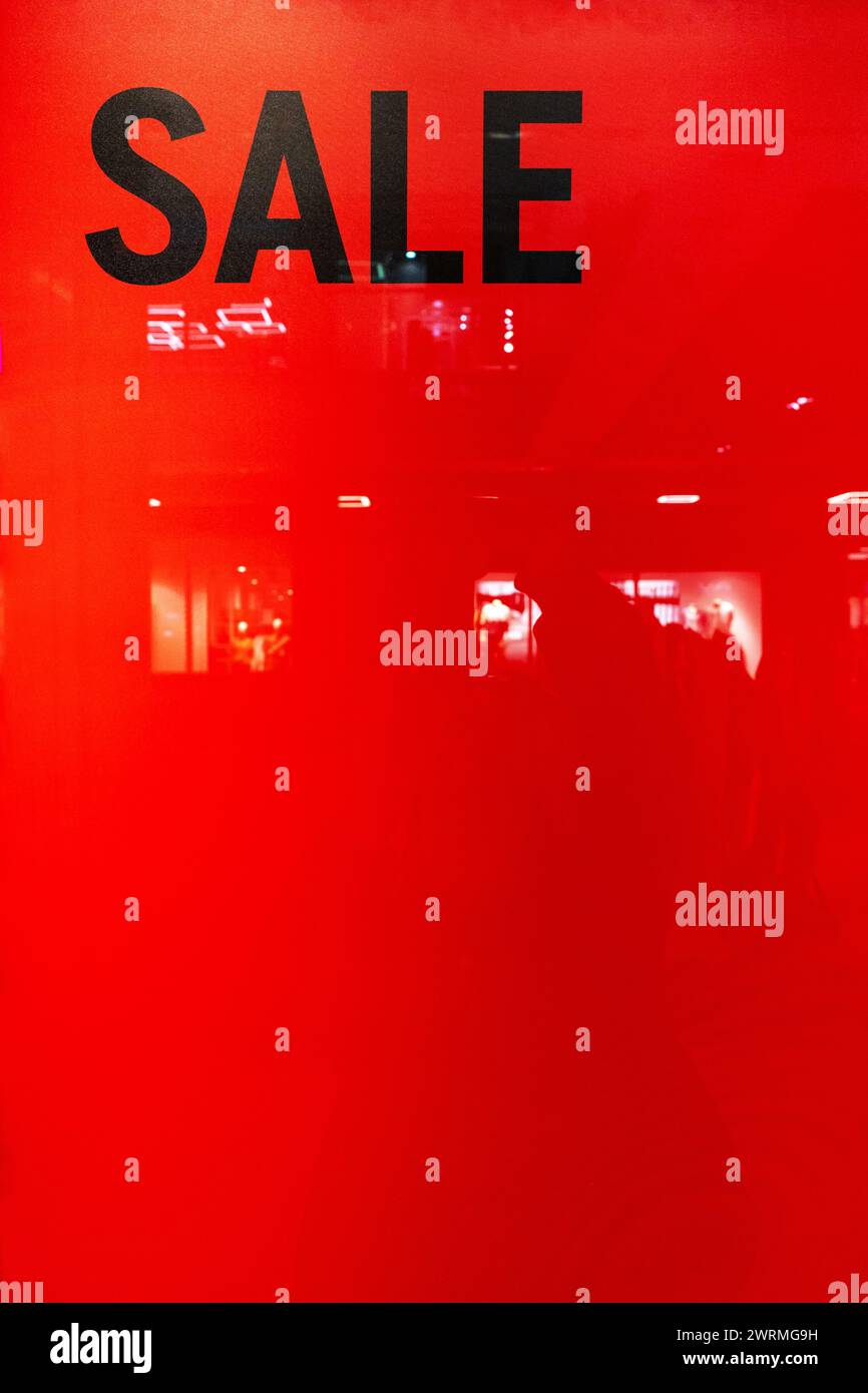 Picture of shop window display with text Sale on red poster. Shopping ...