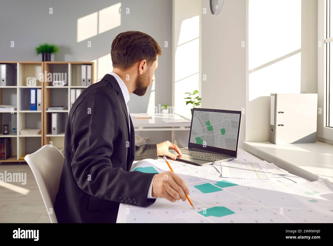 Cadastral surveyor is working with cadastral city maps and using a ...