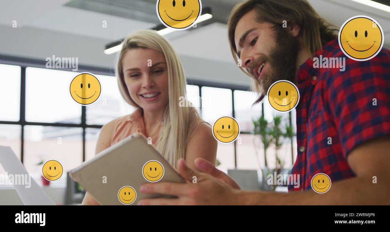 Image of media icons over caucasian business people using tablet Stock ...