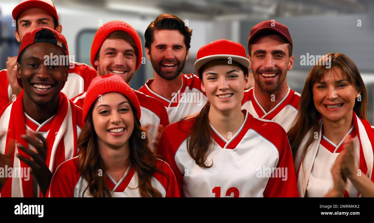Front view of a group of sports fans wearing red and white jerseys ...