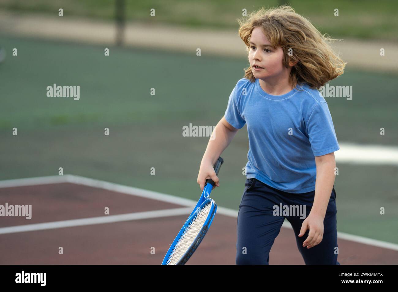 Kid playing tennis on court. Child hit tennis ball with tennis racket ...