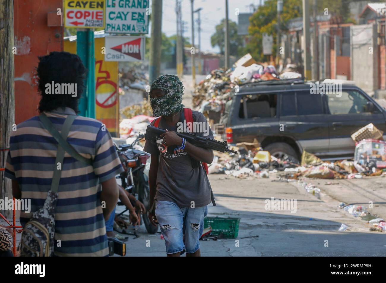 FILE - Armed members of the G9 and Family gang stand guard at their ...