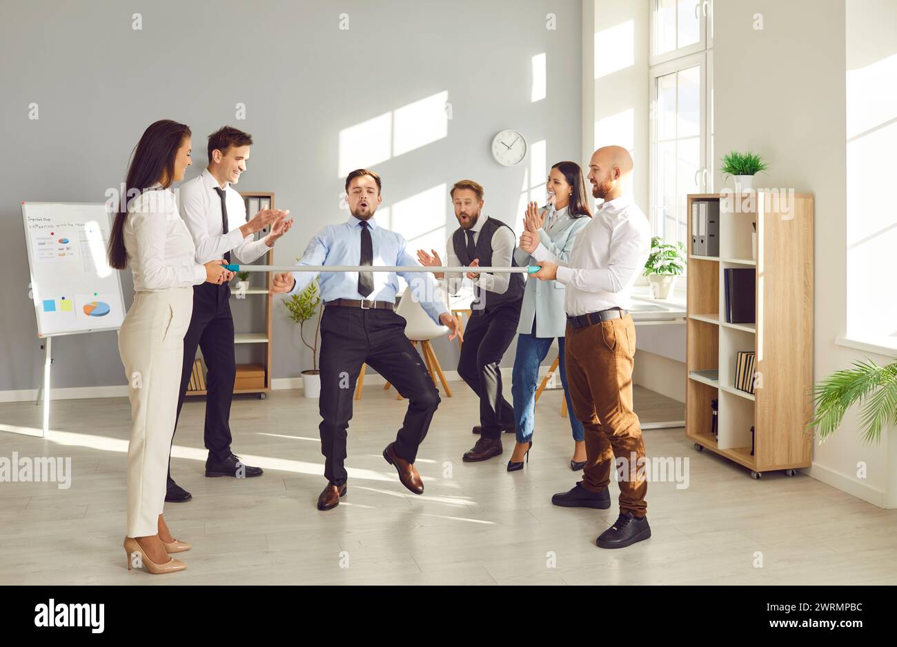 Funny young business people having fun organizing competitions between ...