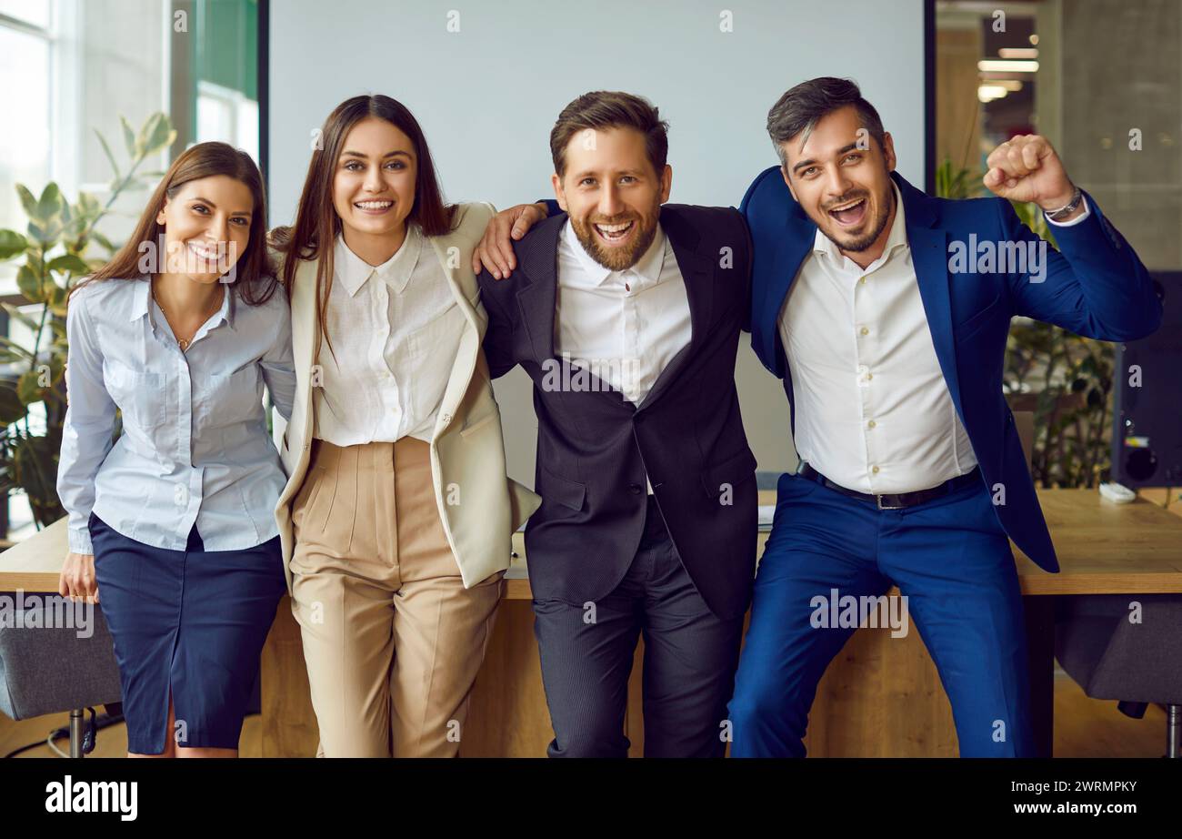 Group of a happy business people looking at camera and having fun ...