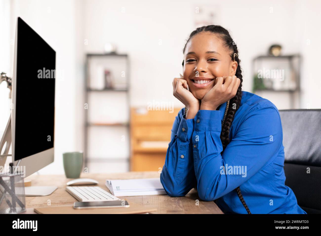 Contented black lady with braids at her computer desk at home Stock ...