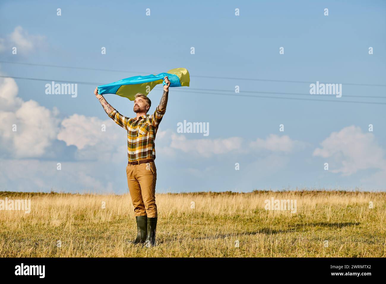 appealing Ukrainian man in casual attire posing with national flag ...