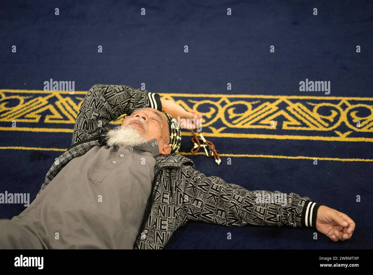 A Muslim takes a nap as he waits to break his fast during the Muslim ...