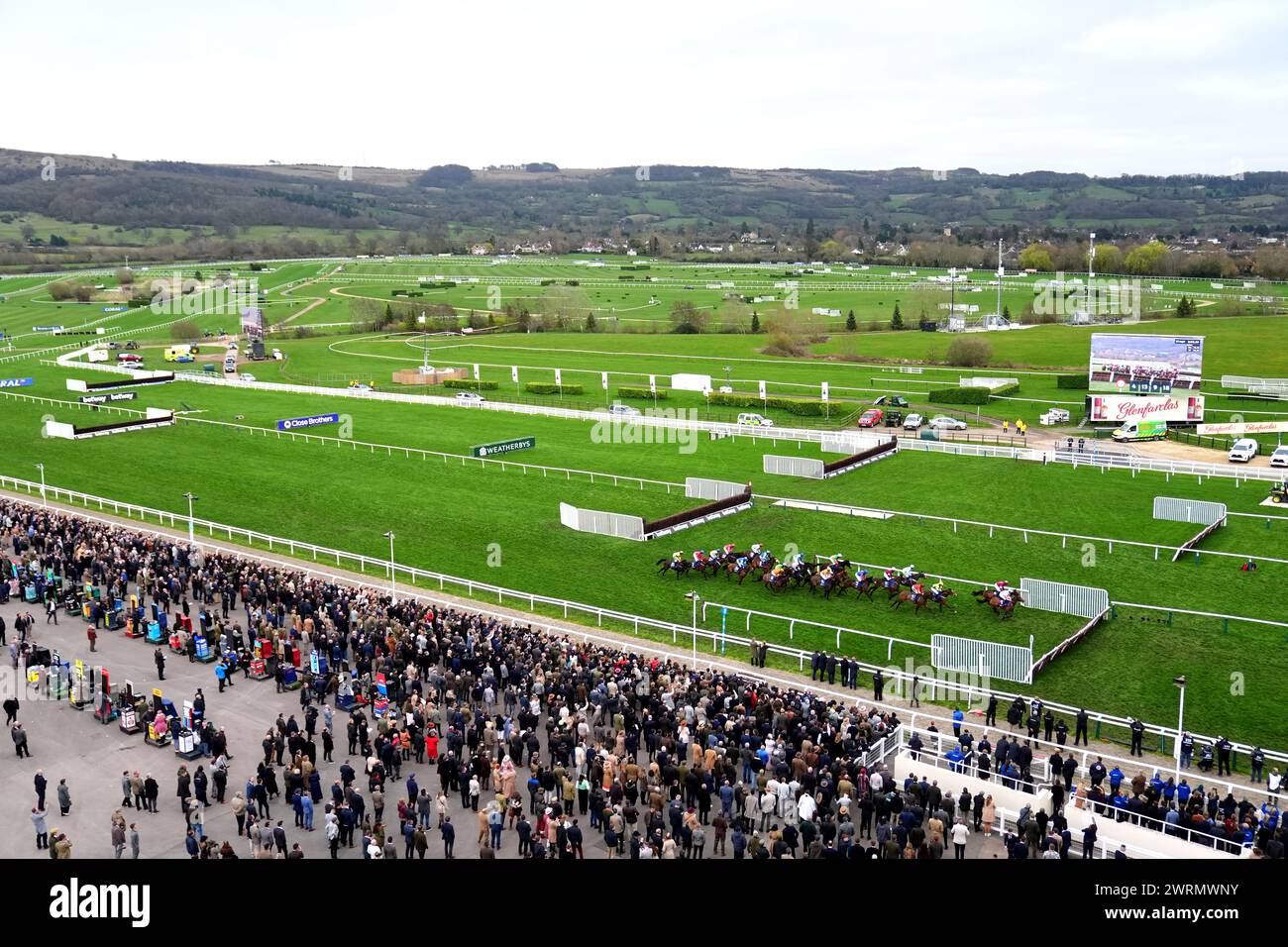 Racegoers watch the runners and riders in action in the Coral Cup ...