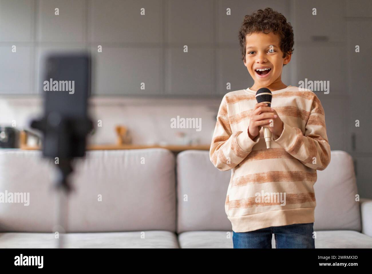 Little Vlogger. Cheerful Black Preteen Boy Singing And Recording Video ...