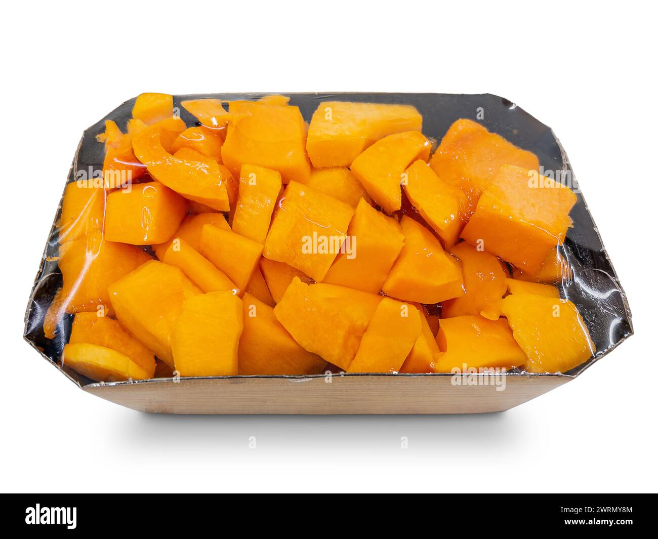Raw pumpkin cleaned and cut into pieces in vacuum-sealed cardboard tray ...