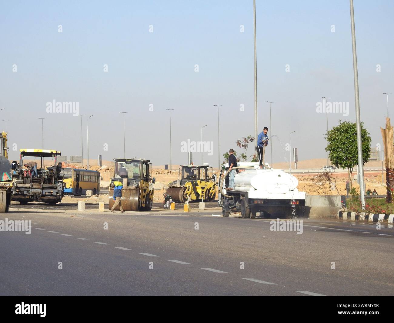Cairo, Egypt, March 2 2024: process of paving a road and making asphalt ...