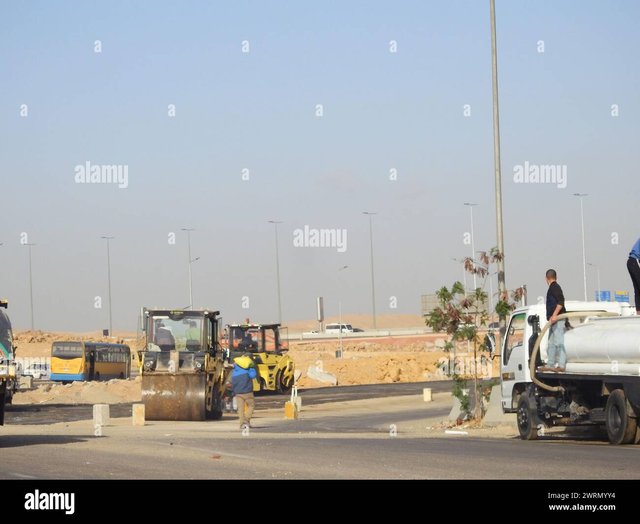 Cairo, Egypt, March 2 2024: process of paving a road and making asphalt ...