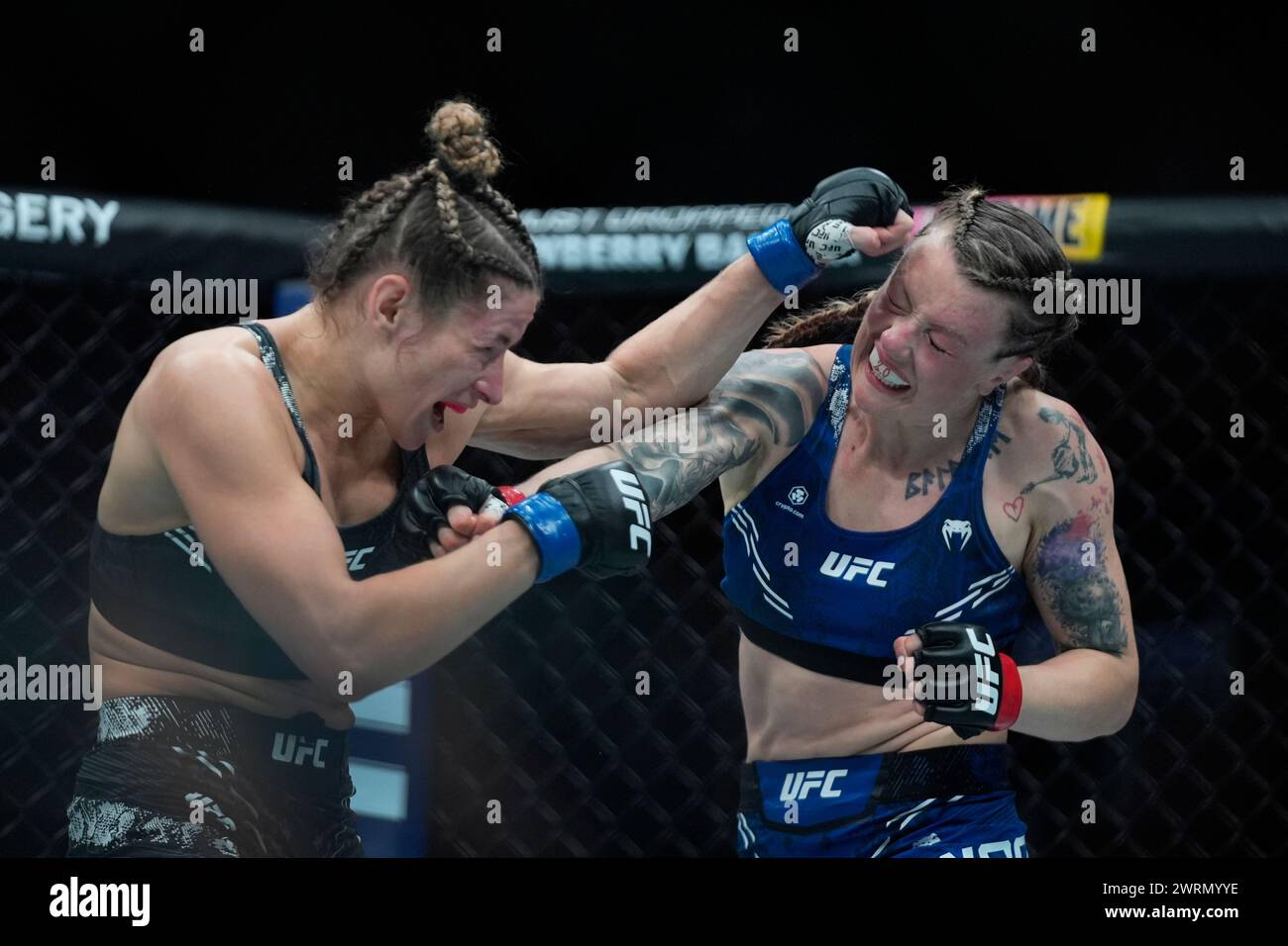 Maryna Moroz, left, lands a blow on Joanne Wood during a UFC 299 mixed ...