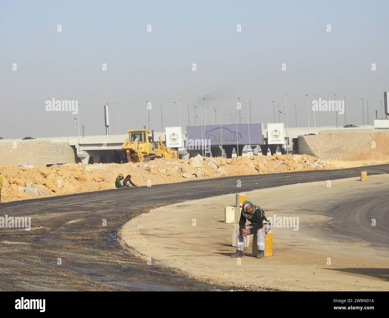 Cairo, Egypt, March 2 2024: process of paving a road and making asphalt ...